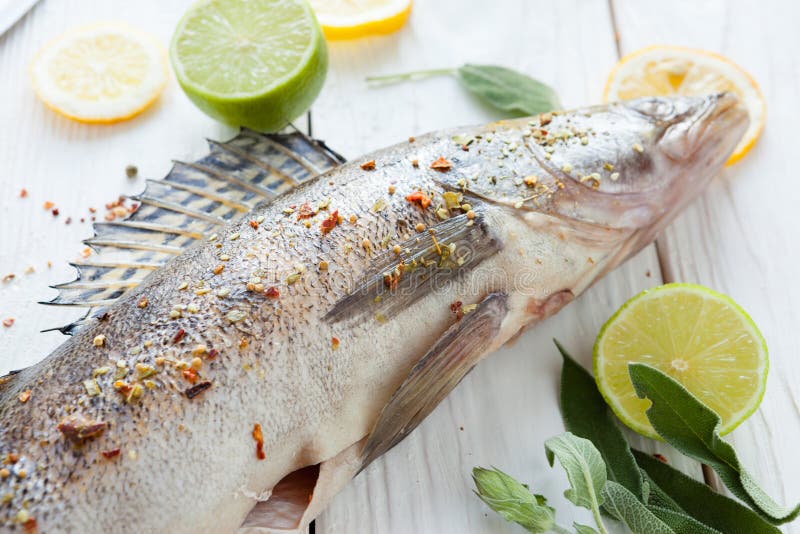 Large Raw Fish and Spices on a Wooden Surface Stock Image - Image of ...