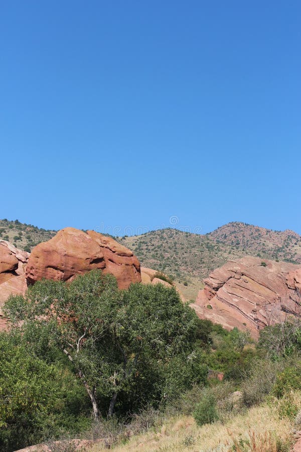 Large Red Rock Formations with Trees, Shrubs and Grasses Growing on and ...