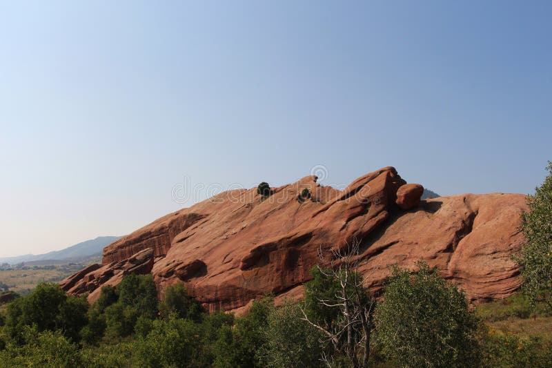 Large Red Rock Formations with Trees, Shrubs and Grasses Growing on and ...