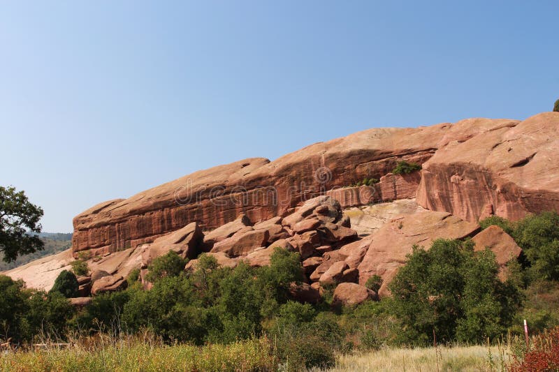 Large Red Rock Formations with Trees, Shrubs and Grasses Growing on and ...