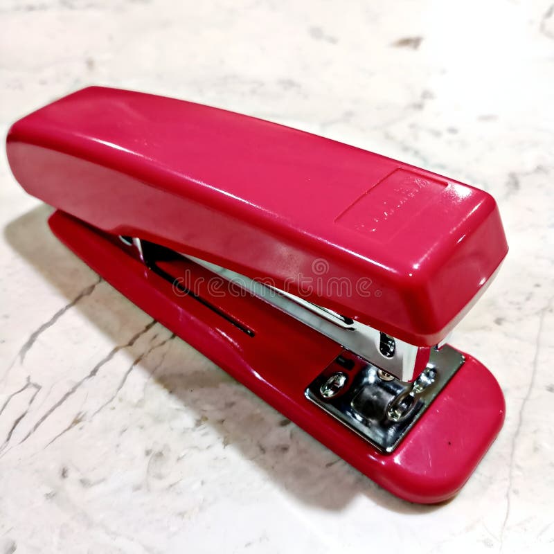 A Large Red Stapler on a Marble Table Stock Image - Image of objects ...