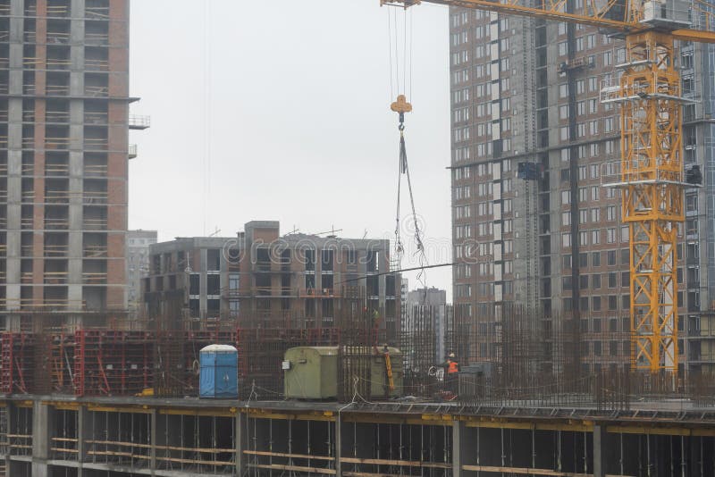 Large Residential Tower Under Construction with Yellow Large Cranes ...