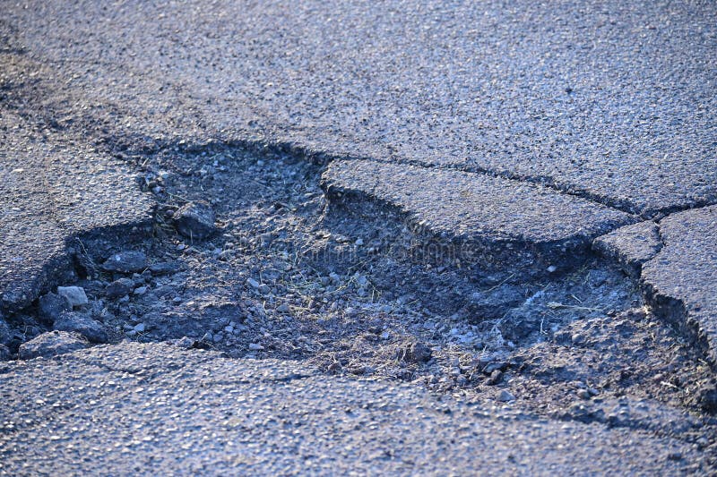 Large Pot Hole in Road with Grass and Cement Stock Image - Image of ...