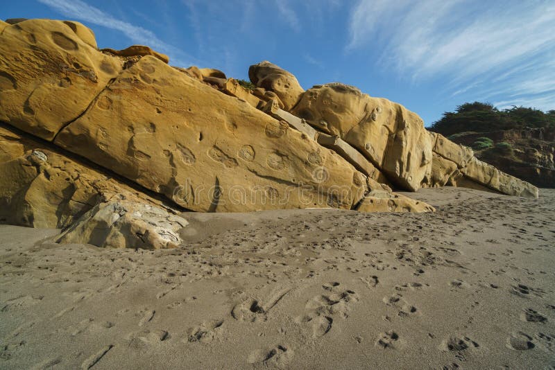 Large Rock Formation Coming Out of Sand Stock Image - Image of large ...