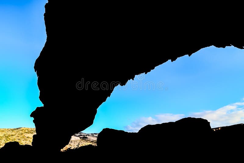 A Large Rock Formation with a Dark Shadow Cast on it Stock Photo ...