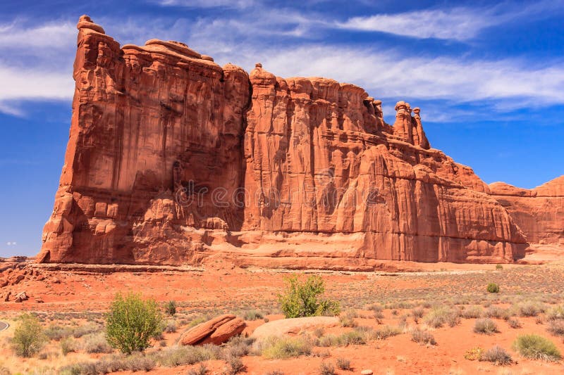 A Large Rock Formation with a Few Trees in the Foreground Stock Image ...
