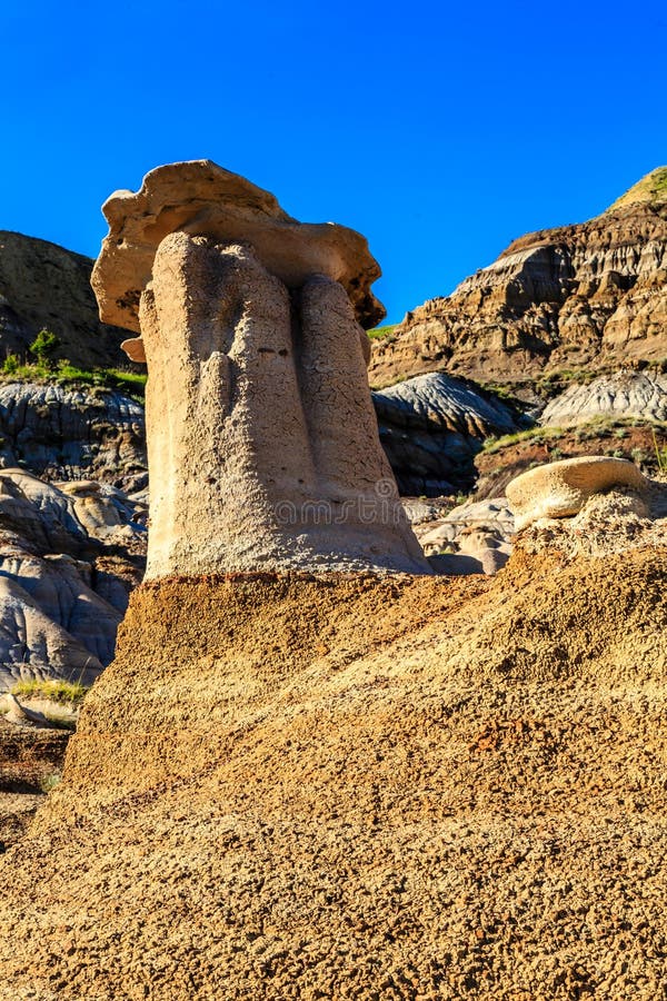 A Large Rock Formation with a Small Hole in the Middle Stock Photo ...