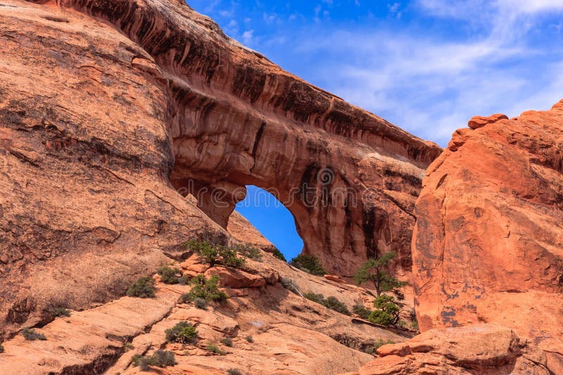 A Large Rock Formation with a Small Hole in the Middle Stock Image ...