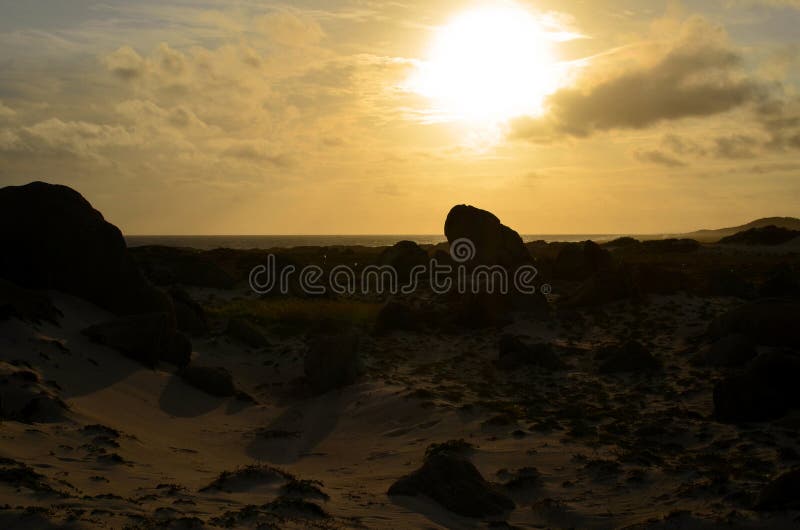 Large Rock Formations Silhouetted at Sunrise in Aruba Stock Photo ...