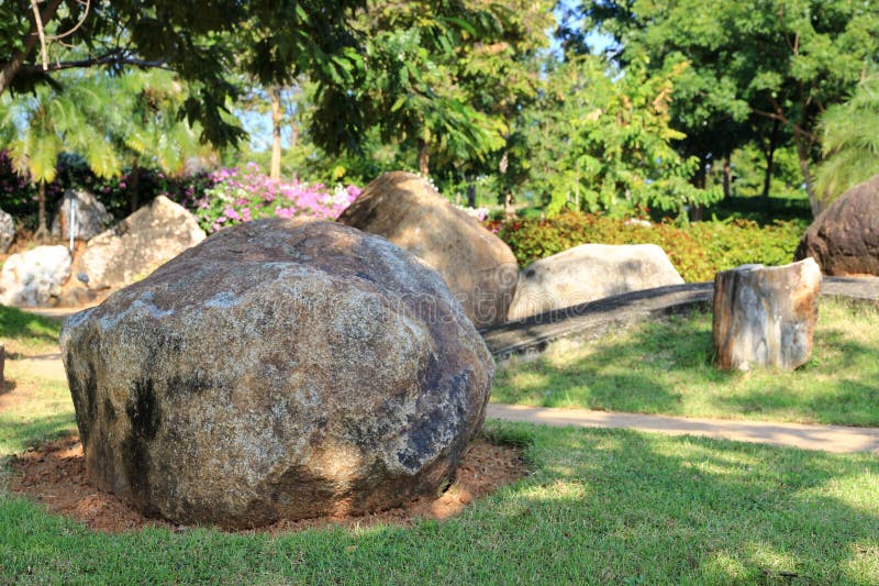 A Large Rock at a Park on the Green Lawn Stock Image - Image of field ...