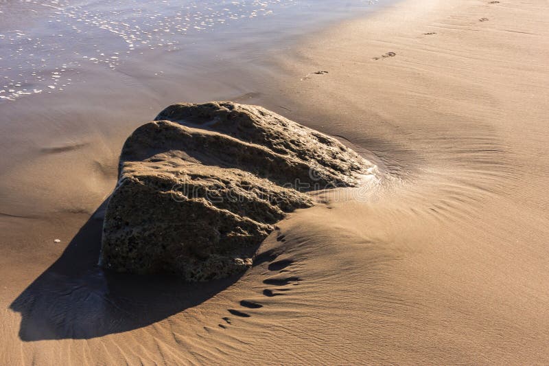 A Rock Sits on Top of a Mountain with the Sun Shining Stock Image ...