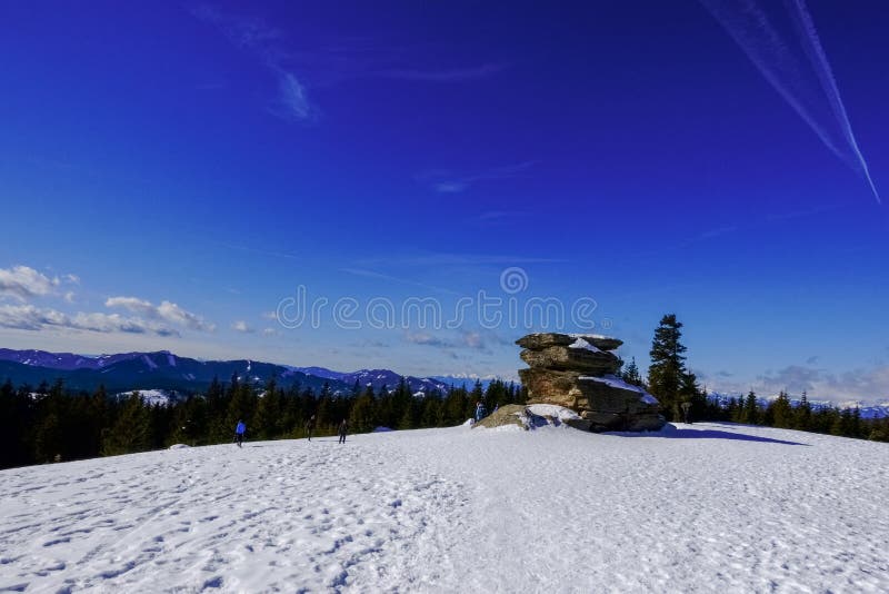 Large Rock on the Top of a Mountain with Snow and Blue Sky Stock Photo ...