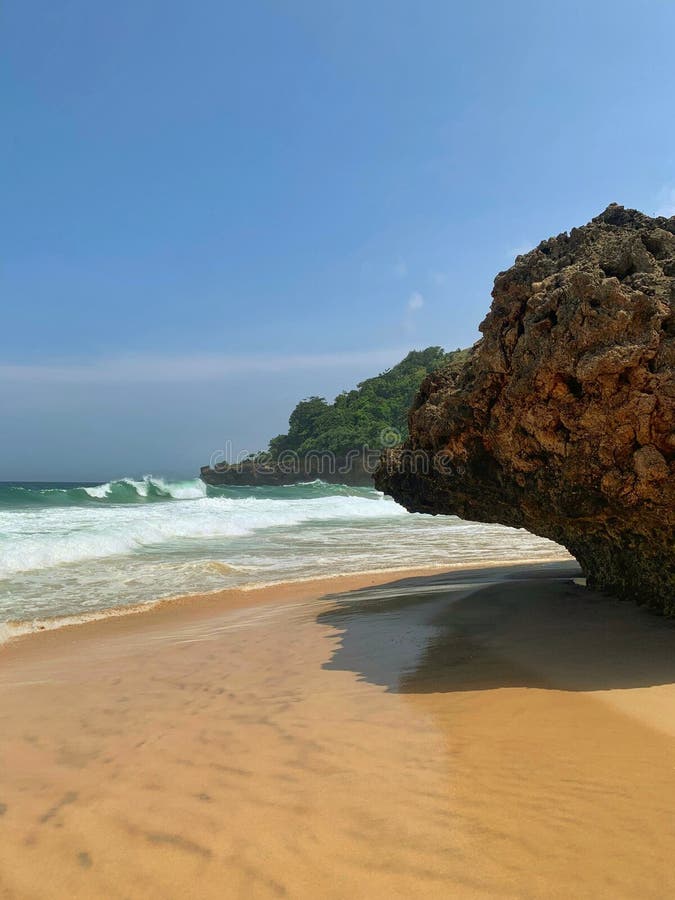 Large Rocks on the Beach Jut Out into the Blue Sea Stock Image - Image ...