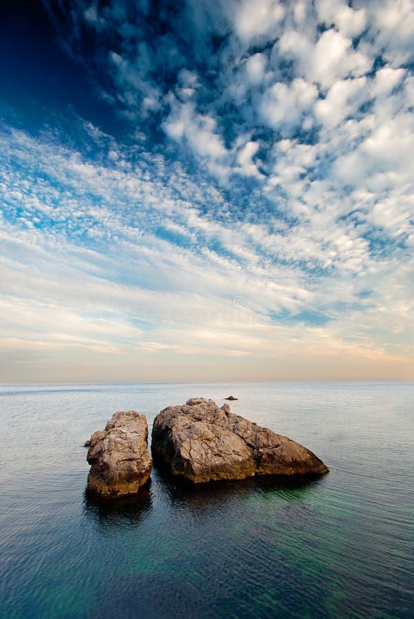 Large rocks in the sea stock photo. Image of dusk, rock - 26346604