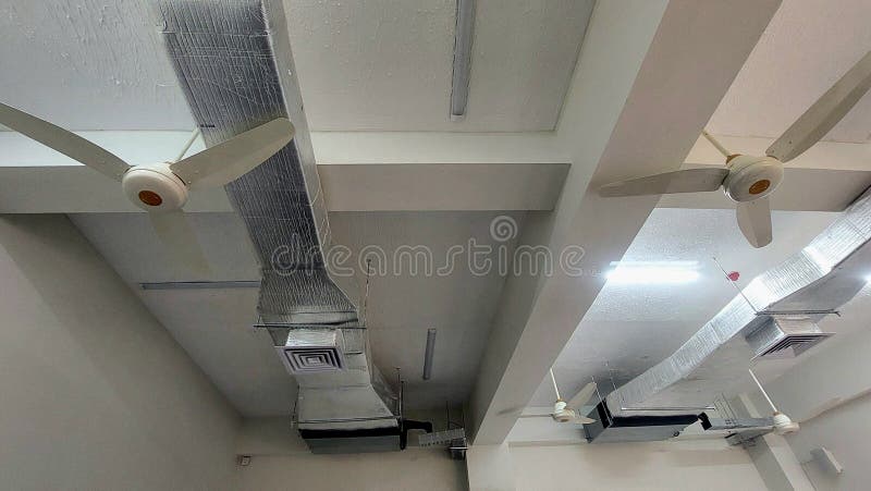 Angled Ceiling View with Aluminum Ductwork Fans and Fluorescent ...