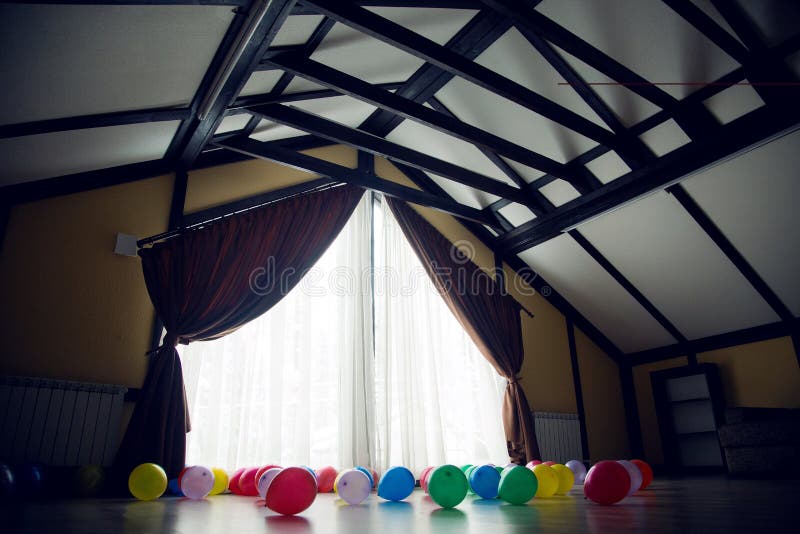 Large Room with a Large Window and Curtains with Inflatable Colored ...