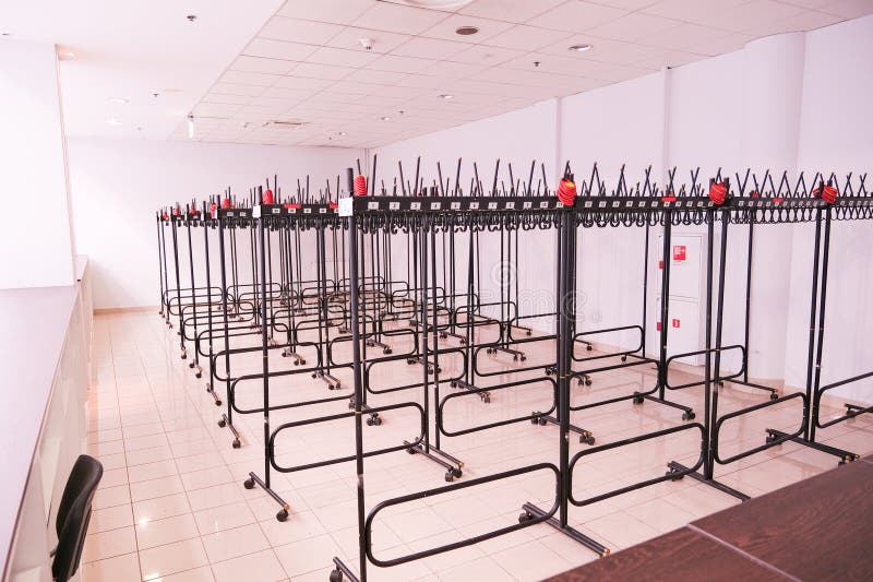 A Large Room with Many Racks of Clothes Stock Photo - Image of empty ...