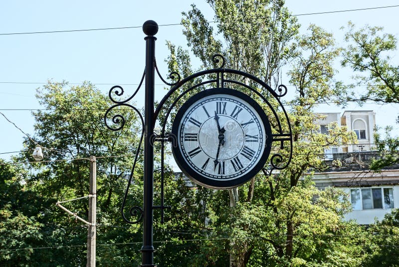 Large Round Clock on a Black Column in the Park Stock Image - Image of ...