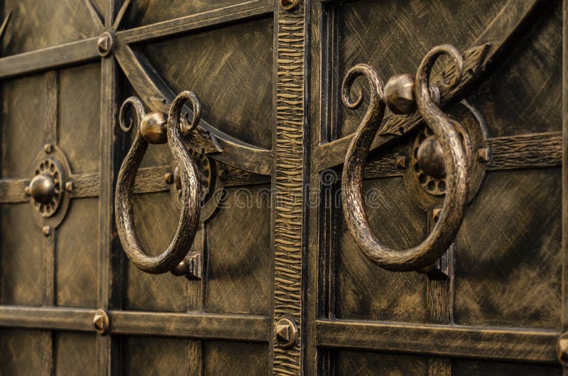 Large Round Forged Door Handles on a Metal Gate Stock Photo - Image of ...