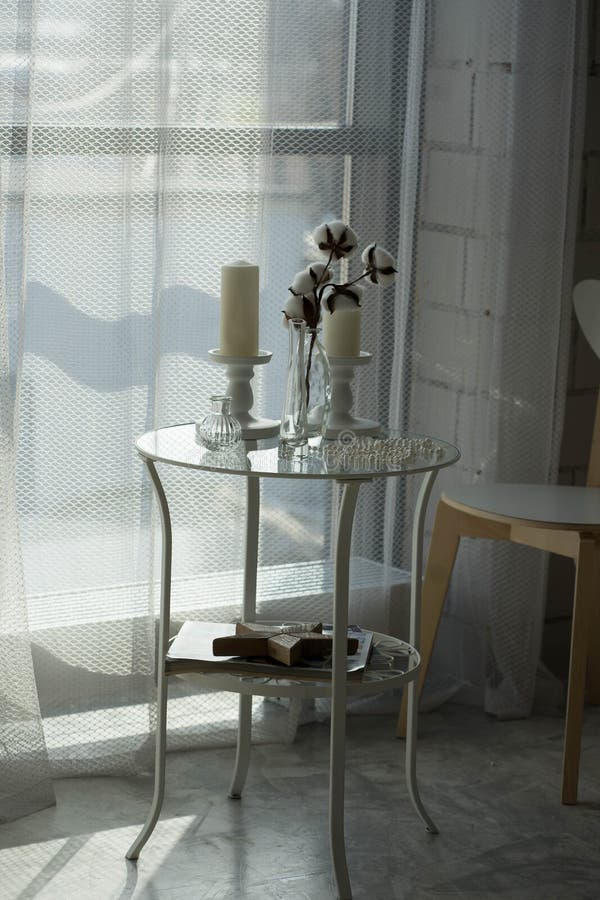 A Large Round Glass Table Stands by the Window with a Vase Stock Image ...