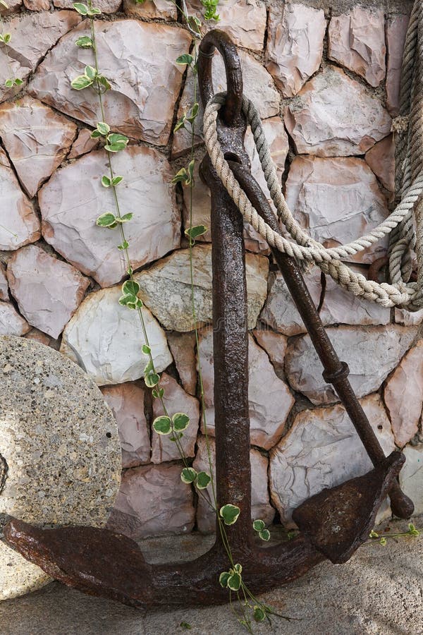 Large Rusty Anchor with Rope Against a Wall Outside Stock Photo - Image ...