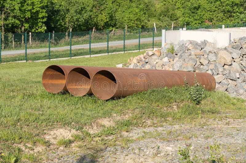 Large Rusty Pipes Lie at a Construction Site, Welded from Sheets of ...