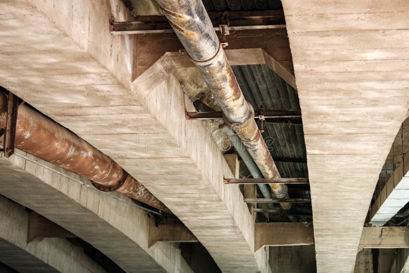 Large Rusty Pipes Under a Bridge in Poor Condition Stock Photo - Image ...