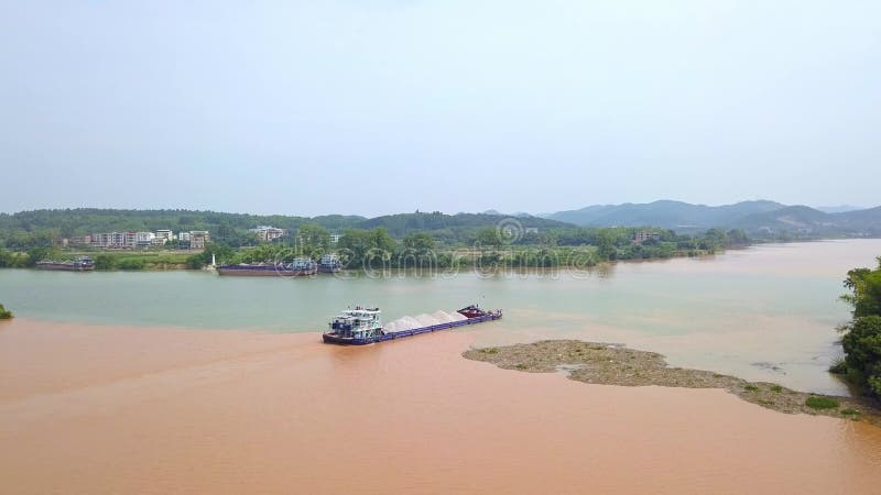 A Large Sand Mining Ship Sailed Past the Confluence of Two Rivers, the ...