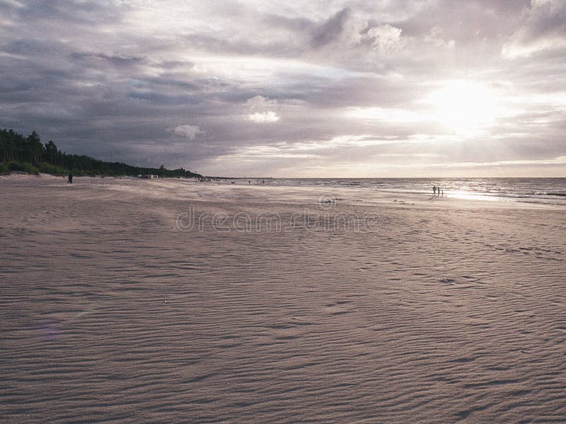 Large Sandy Beach with Gray Wavy Water Under Dramatic Bright Cloudy Sky ...