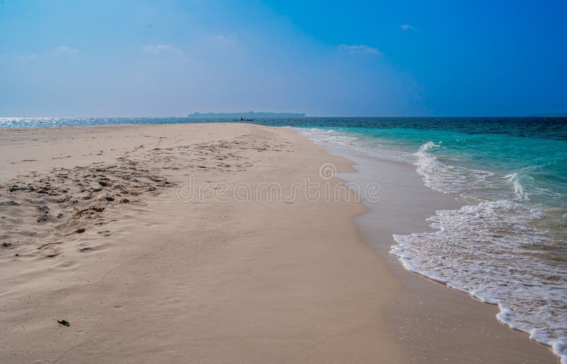 Large Sandy Beach with a View of the Ocean and an Island on the Horizon ...