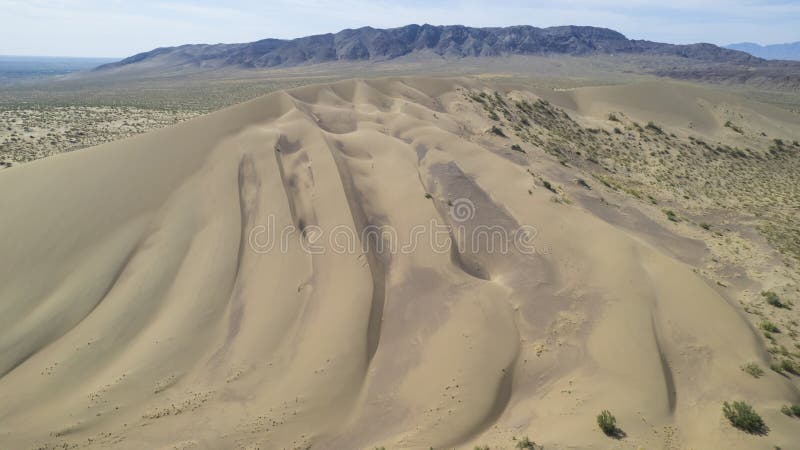 A Large Sandy Dune in the Middle of the Steppe Stock Photo - Image of ...