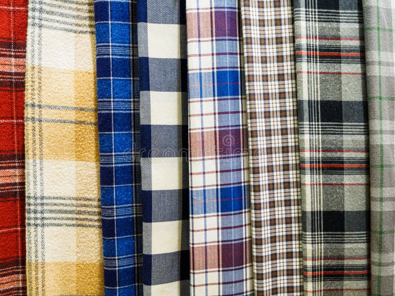 A Large Selection of Bright Plaid Fabrics in the Fabric Store. Close-up ...