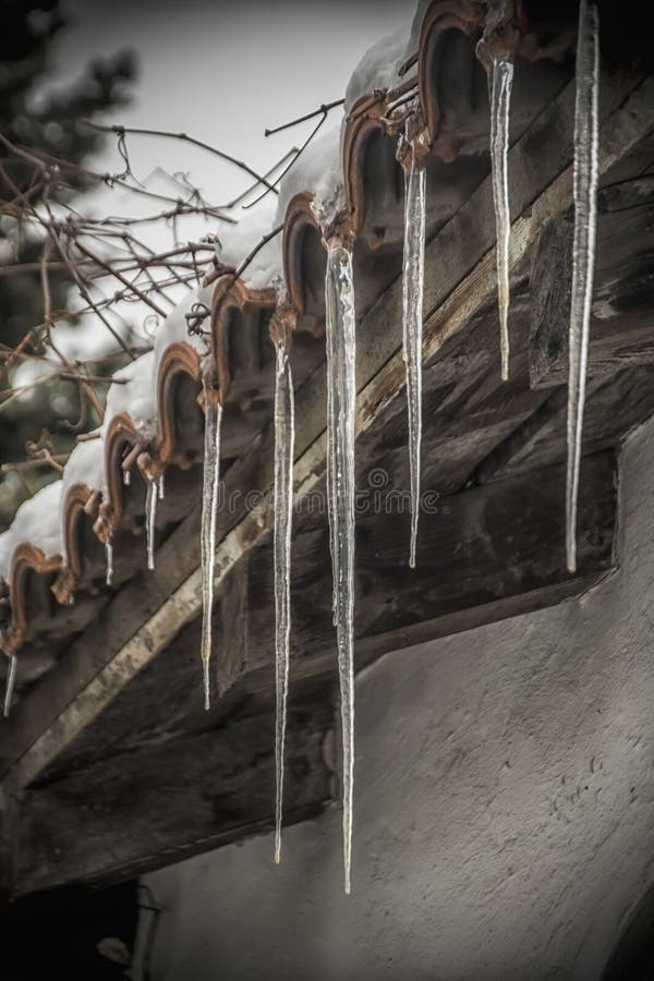 Sharp icicles on a rooftop stock image. Image of cold - 243170915