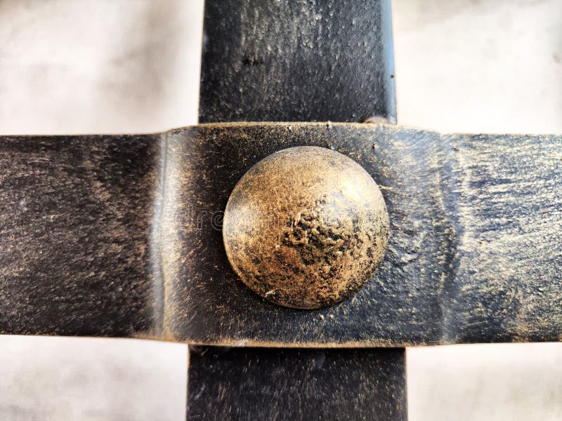 A Large Shiny Copper Round Metal Rivet at the Intersection and Cross of ...