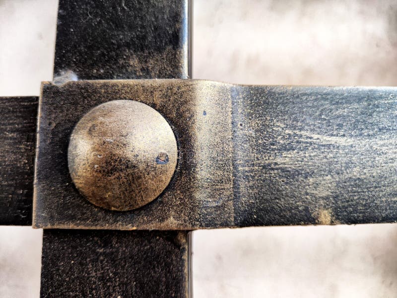 A Large Shiny Copper Round Metal Rivet at the Intersection and Cross of ...