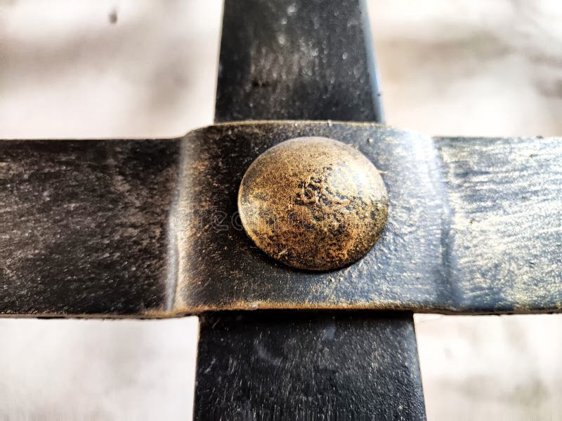 A Large Shiny Copper Round Metal Rivet at the Intersection and Cross of ...