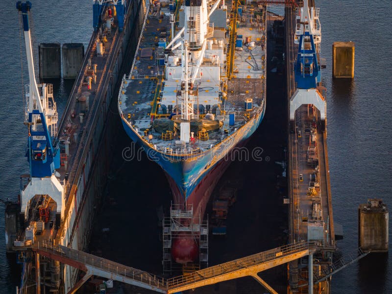 Large Ship in Dry Dock with Cranes at Riga Shipyard in Warm Sunlight ...