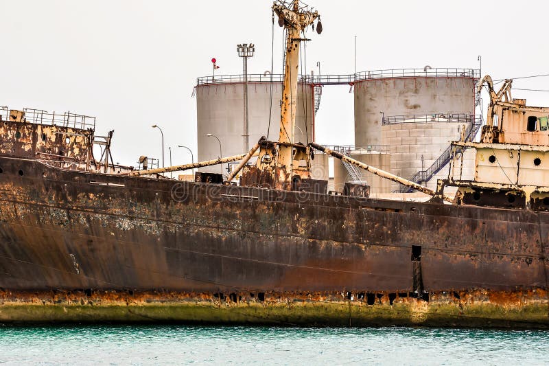 A Large Ship is Sitting in the Water with a Lot of Rust on it Stock ...