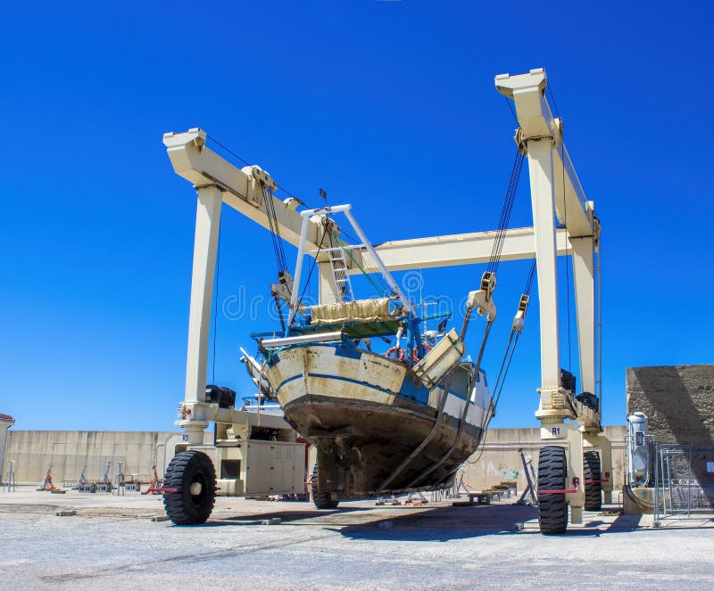Large Ship Under Repair. a Ship in the Port, a Crane Working on the ...
