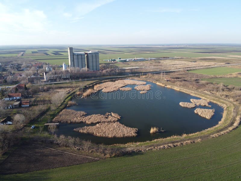 Large silo by the lake stock photo. Image of green, field - 191222202