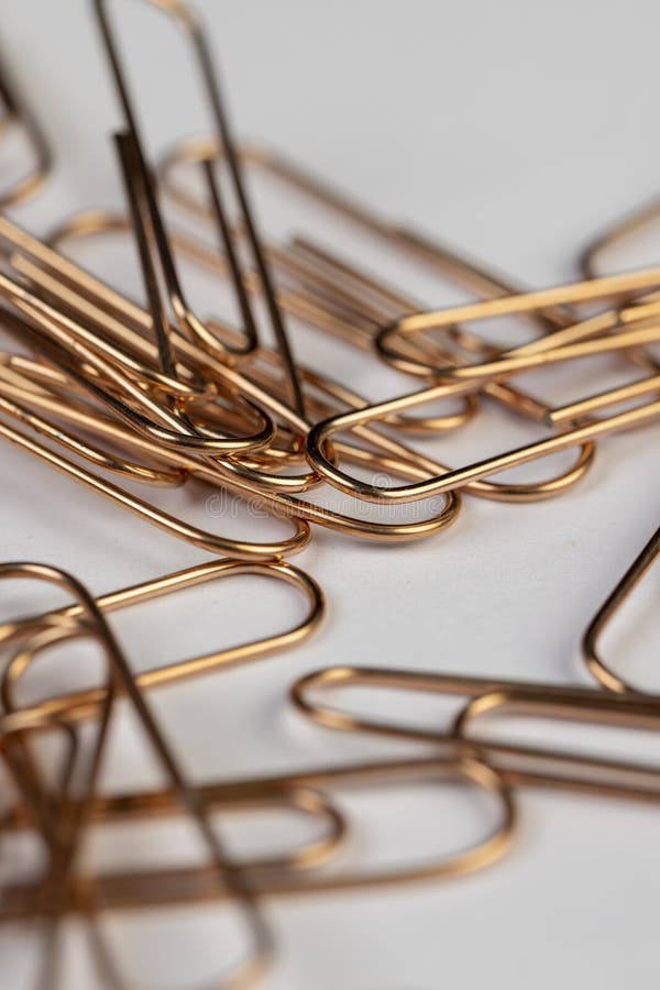 Large-sized Copper Paper Clips Lie on White Blank Paper Stock Photo ...