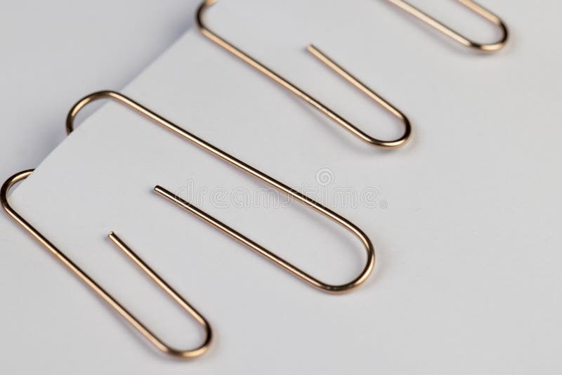 Large-sized Copper Paper Clips Lie on White Blank Paper Stock Image ...