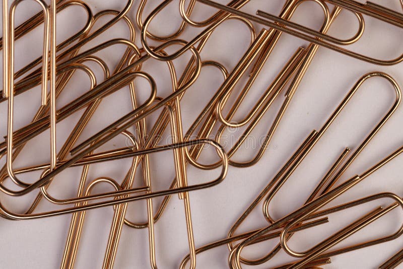 Large-sized Copper Paper Clips Lie on White Blank Paper Stock Photo ...