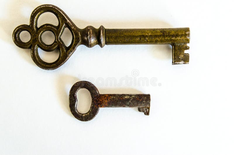 Large and Small Antique Brass Skeleton Keys on White Background Stock ...