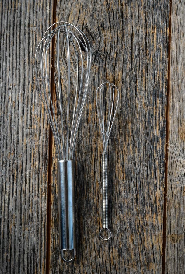 Large and Small Whisk on Rustic Wood Background Stock Image - Image of ...
