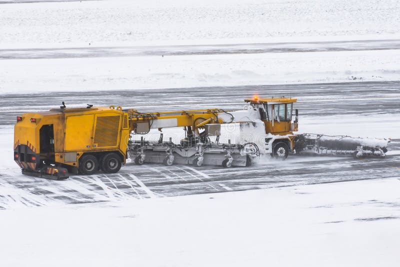 Large Snow Plowing Machine at Work on the Road during a Snow Storm in ...