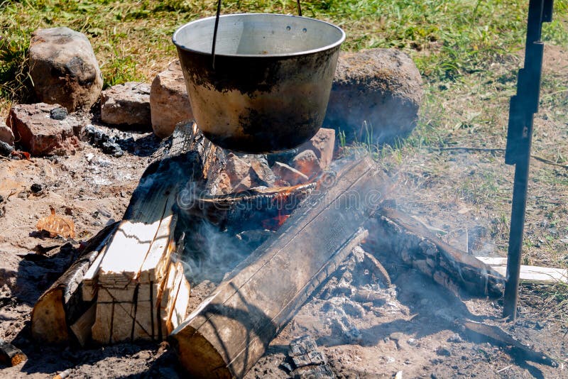 A Large Pot Hangs Over a Burning Fire Stock Photo - Image of metal ...