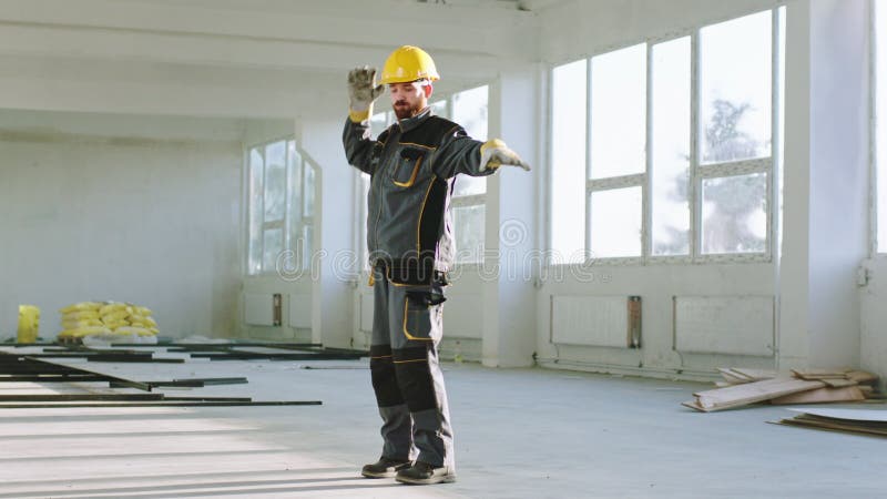 In a Large Space Construction Building Excited Engineer Man at the End ...