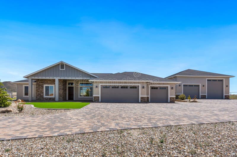 A Large, Spacious House that Features Three Garages and a Long Driveway ...