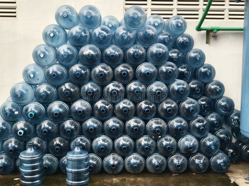 Large Stack of Blue Plastic Reusable Water Cooler Gallons Arranged in a ...